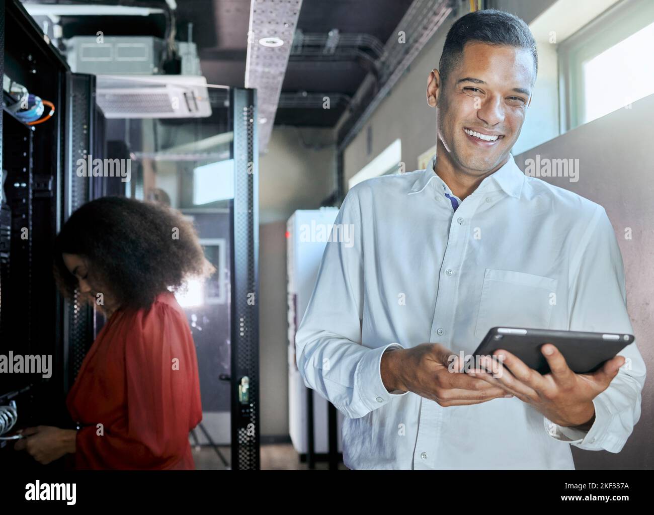 Server room, employees and man with tablet working on internet or web ...