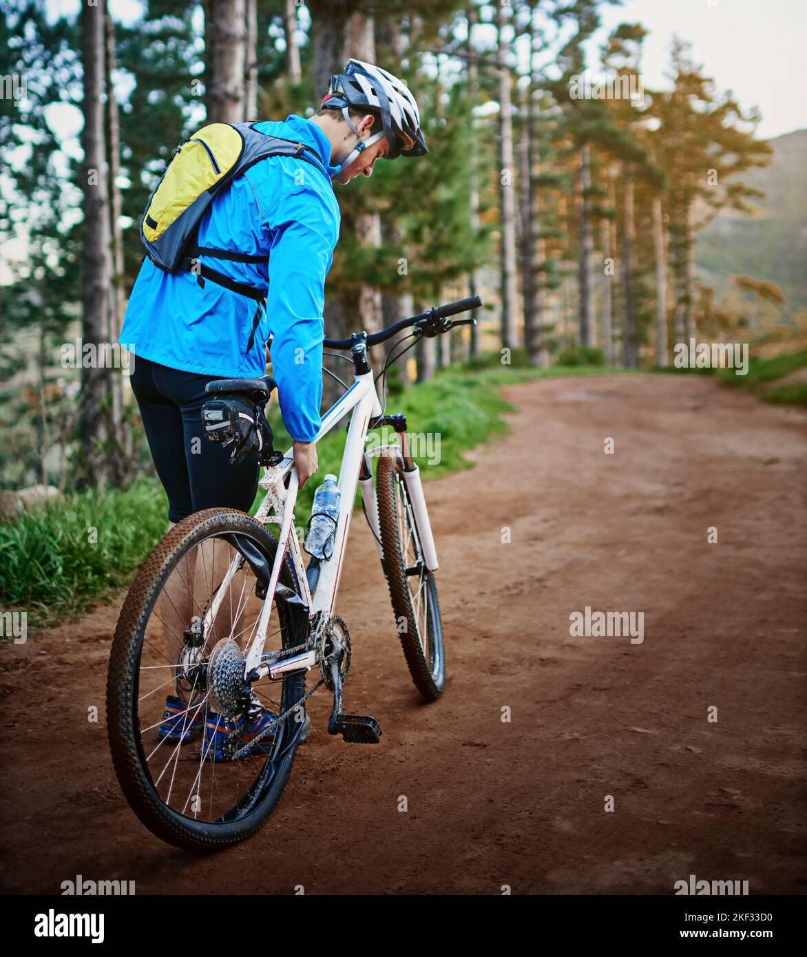 Get out and explore. a male cyclist out for a ride on his mountain bike ...
