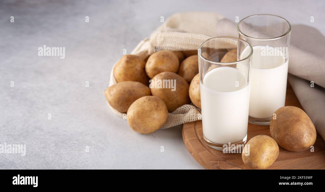 Vegan plant based milk in two transparent glasses. Alternative potato ...
