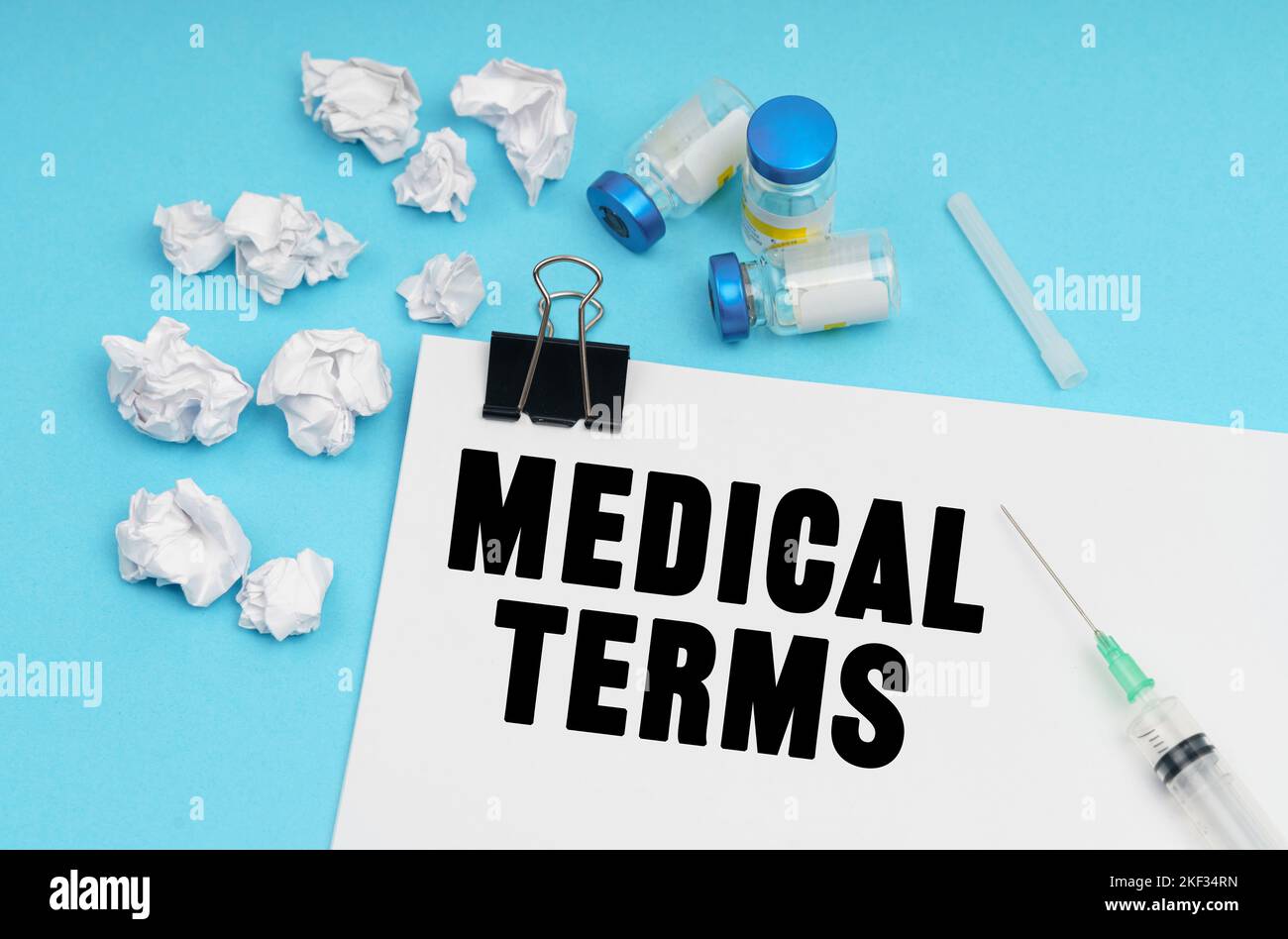 Medicine concept. On a blue background, a syringe, medicine, white ...