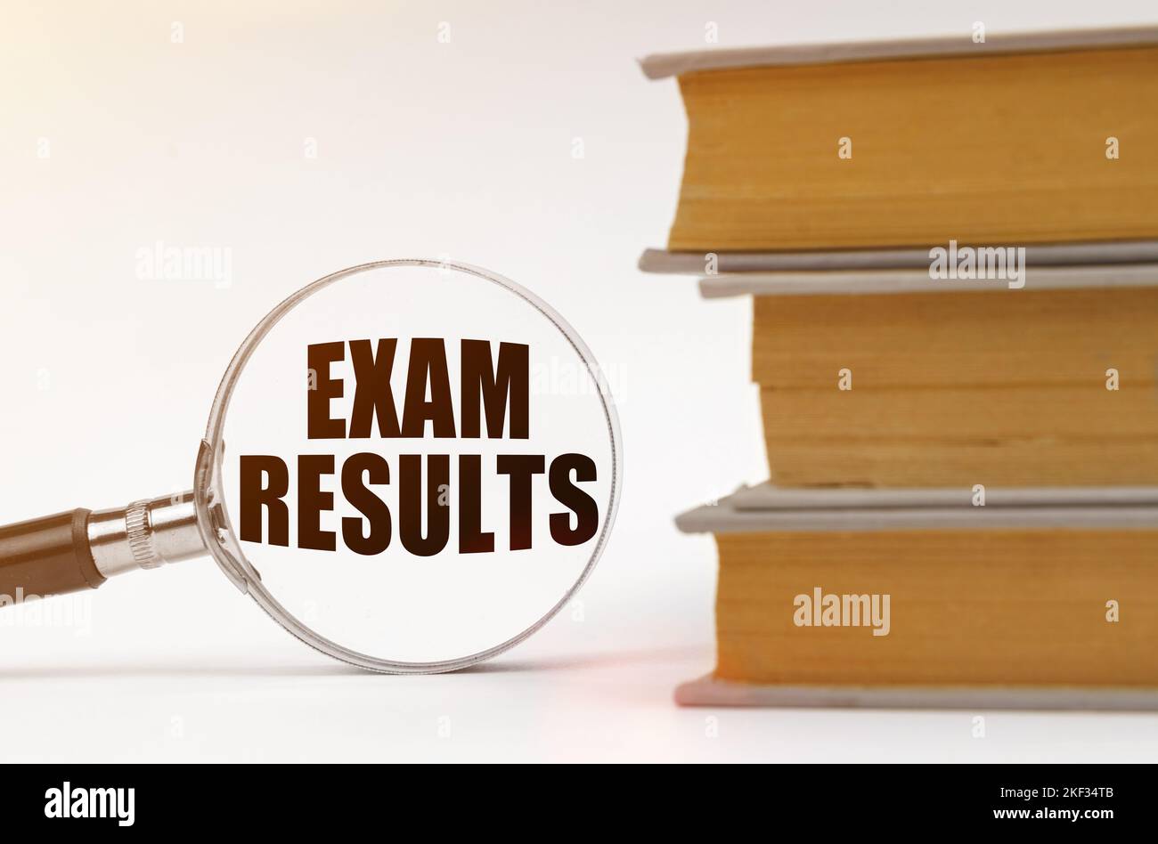 Education concept. On a white background, books and a magnifying glass ...