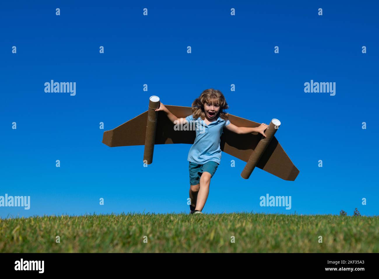 Happy child playing with toy jetpack. Kid pilot having fun outdoor ...