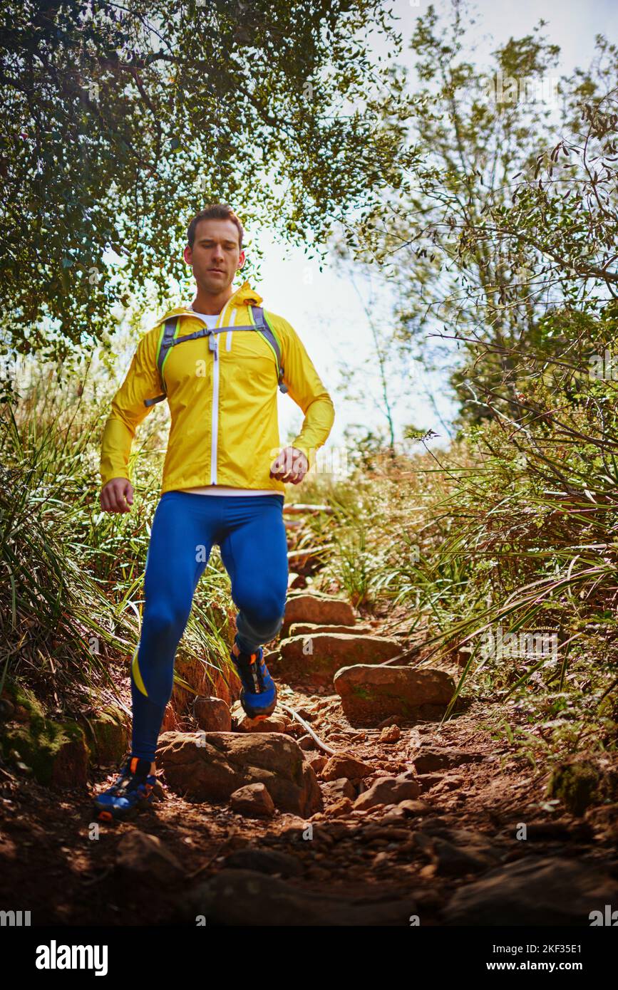 Taking in natures beauty on the run. a young man running along a nature ...