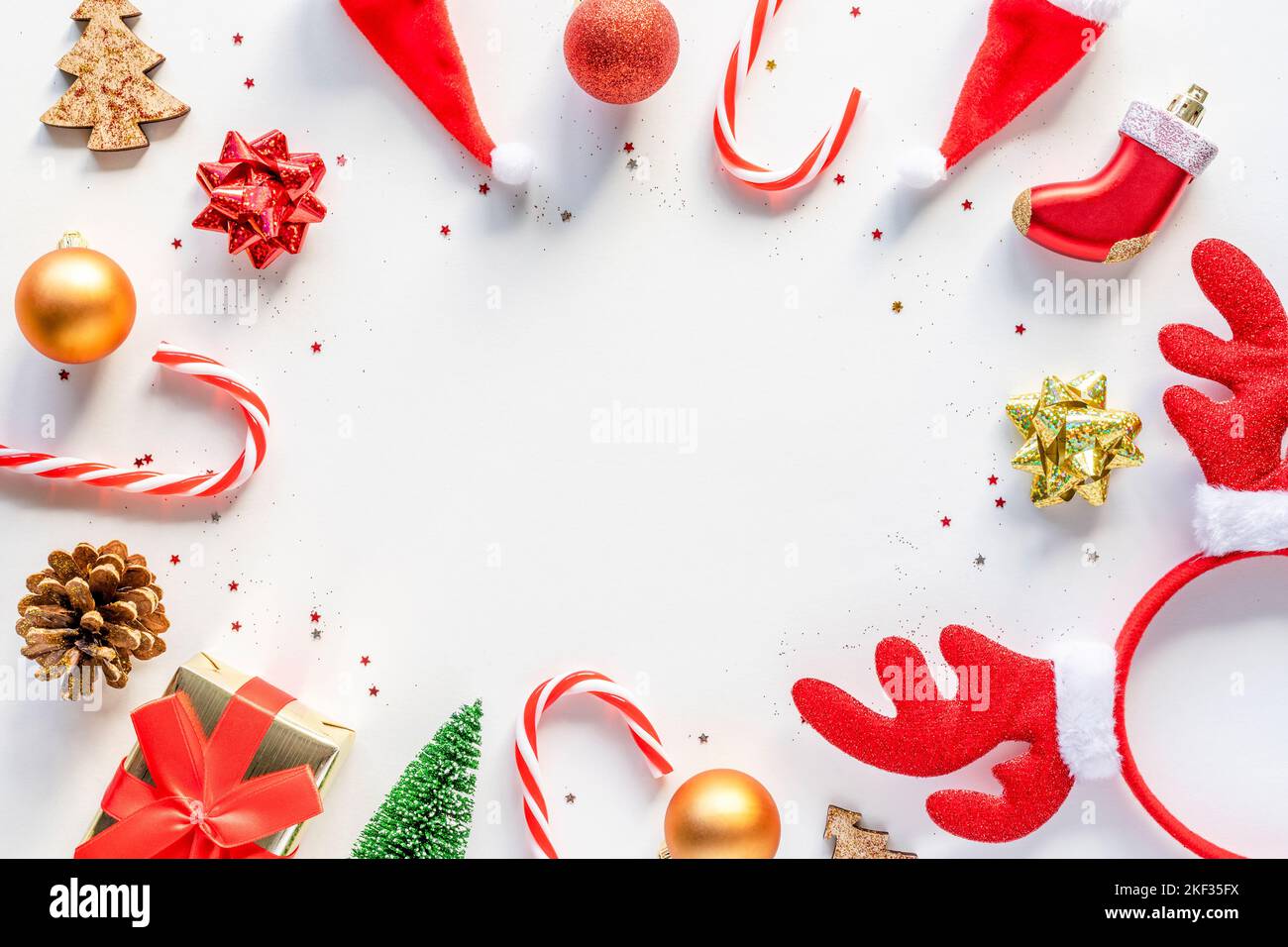 Bright Christmas flatlay frame of holiday decorations on white ...