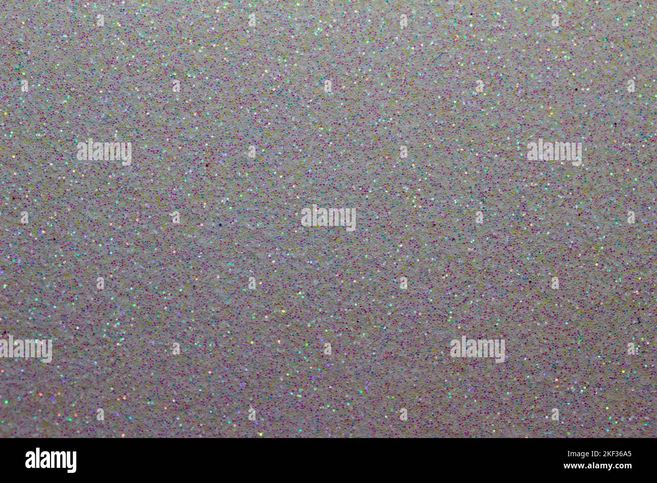 Full frame macro image of a silver pink color sparkling glitter texture ...