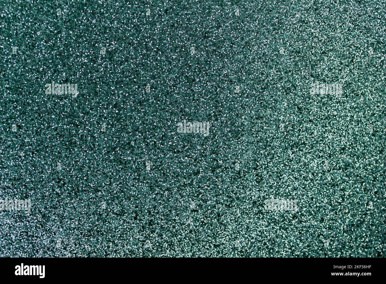 Full frame macro image of a spruce green color sparkling glitter ...