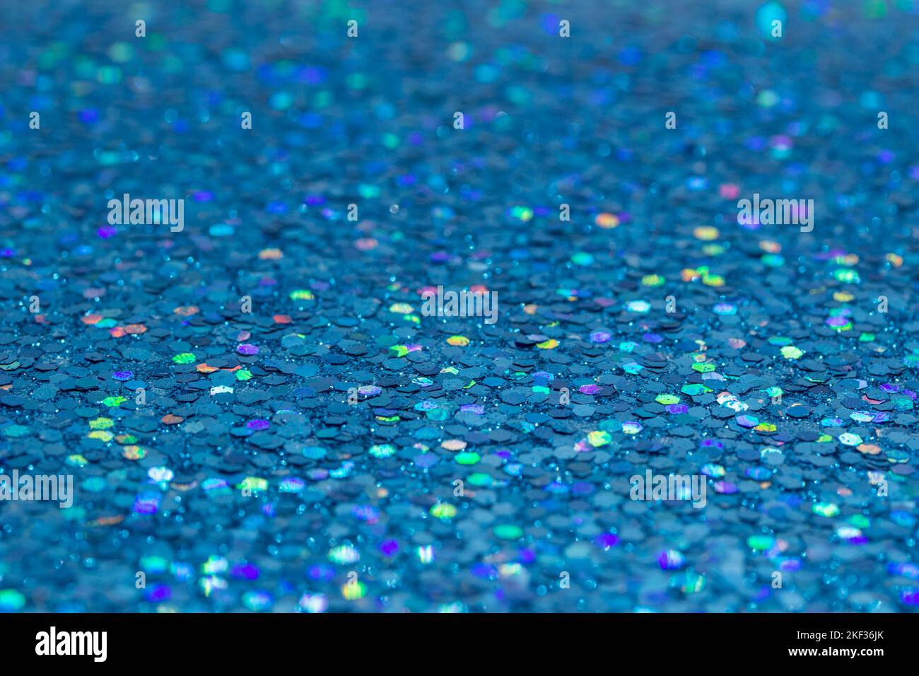 Full frame macro image of a blue color sparkling glitter texture ...