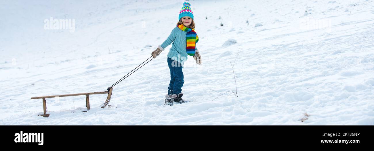 Winter banner. Child sledding in winter snowy forest. Kids with sled ...