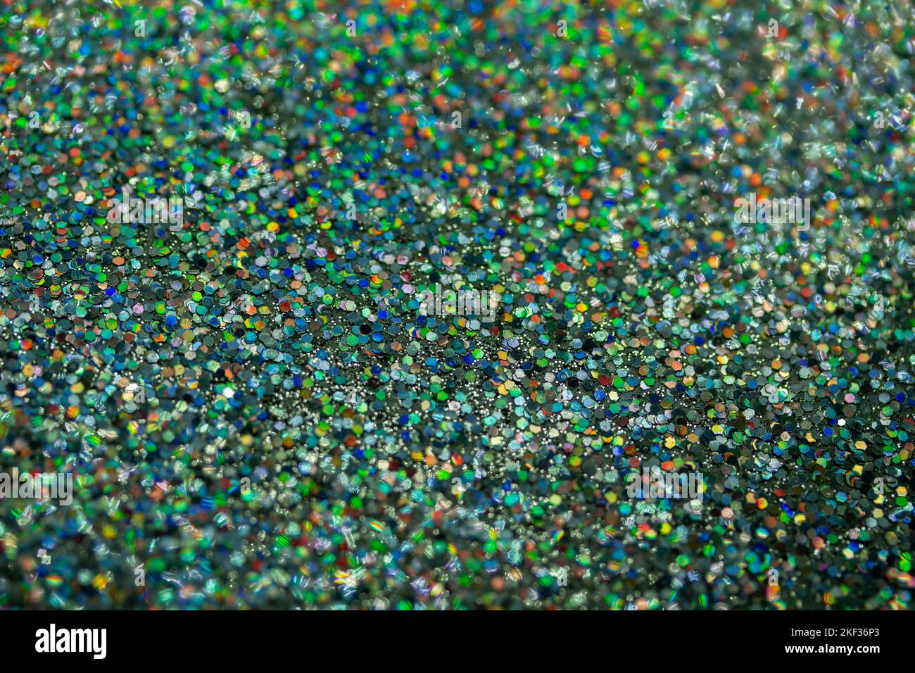 Full frame macro image of a green color sparkling glitter texture ...
