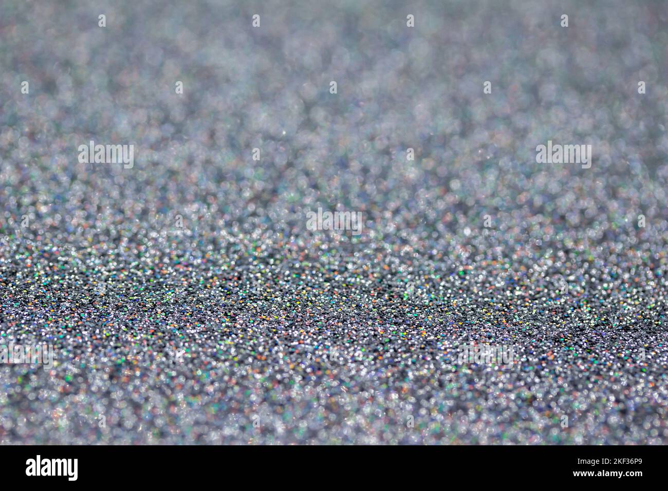 Full frame macro image of a silver color sparkling glitter texture ...