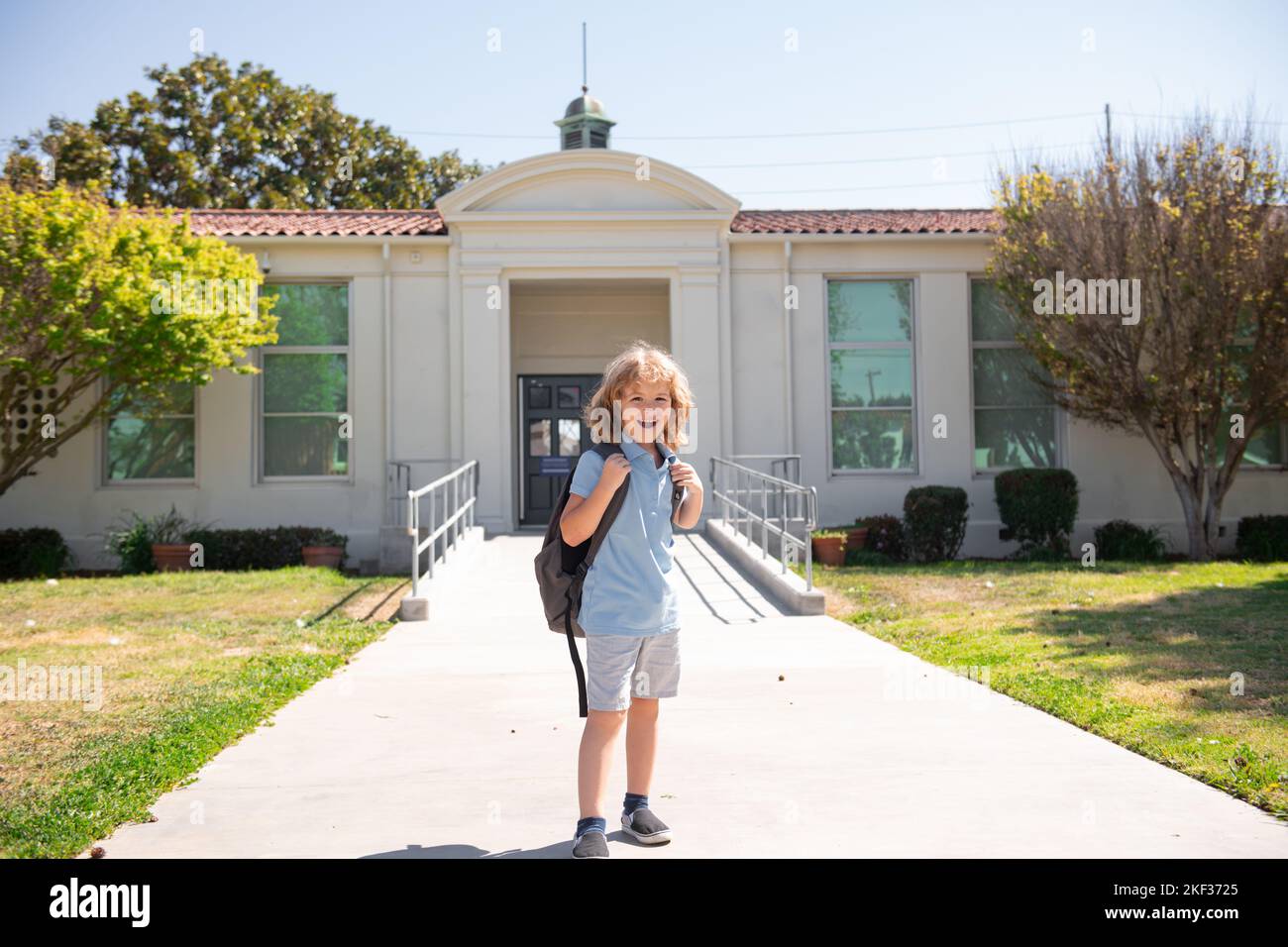 Elementary school kid running at the school. Pupil go study with ...