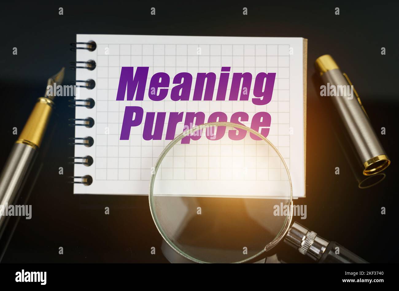 Business and Economics. On the black surface is a pen, a magnifying ...