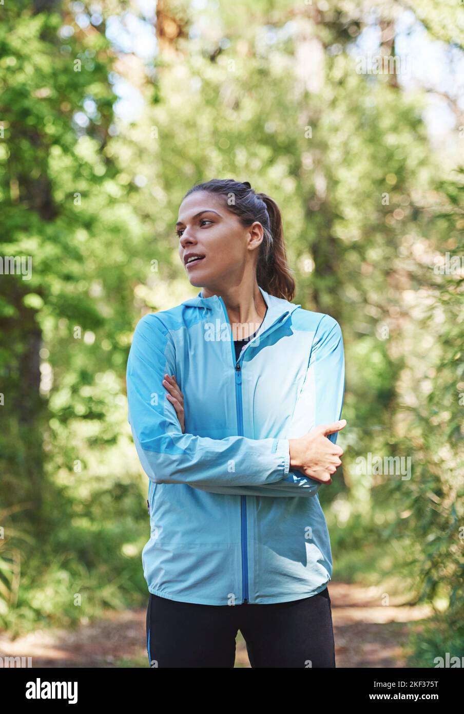 Taking in the trail. a woman taking a breather while out for a train ...