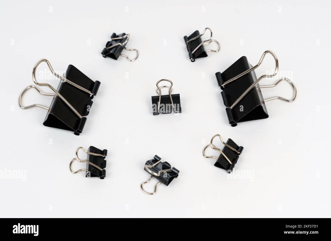 Office. Black clips of different sizes are on a white background Stock ...