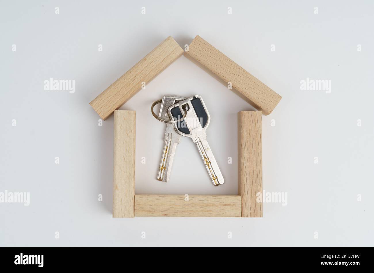 Business concept. On a white background, a small house made of wooden ...