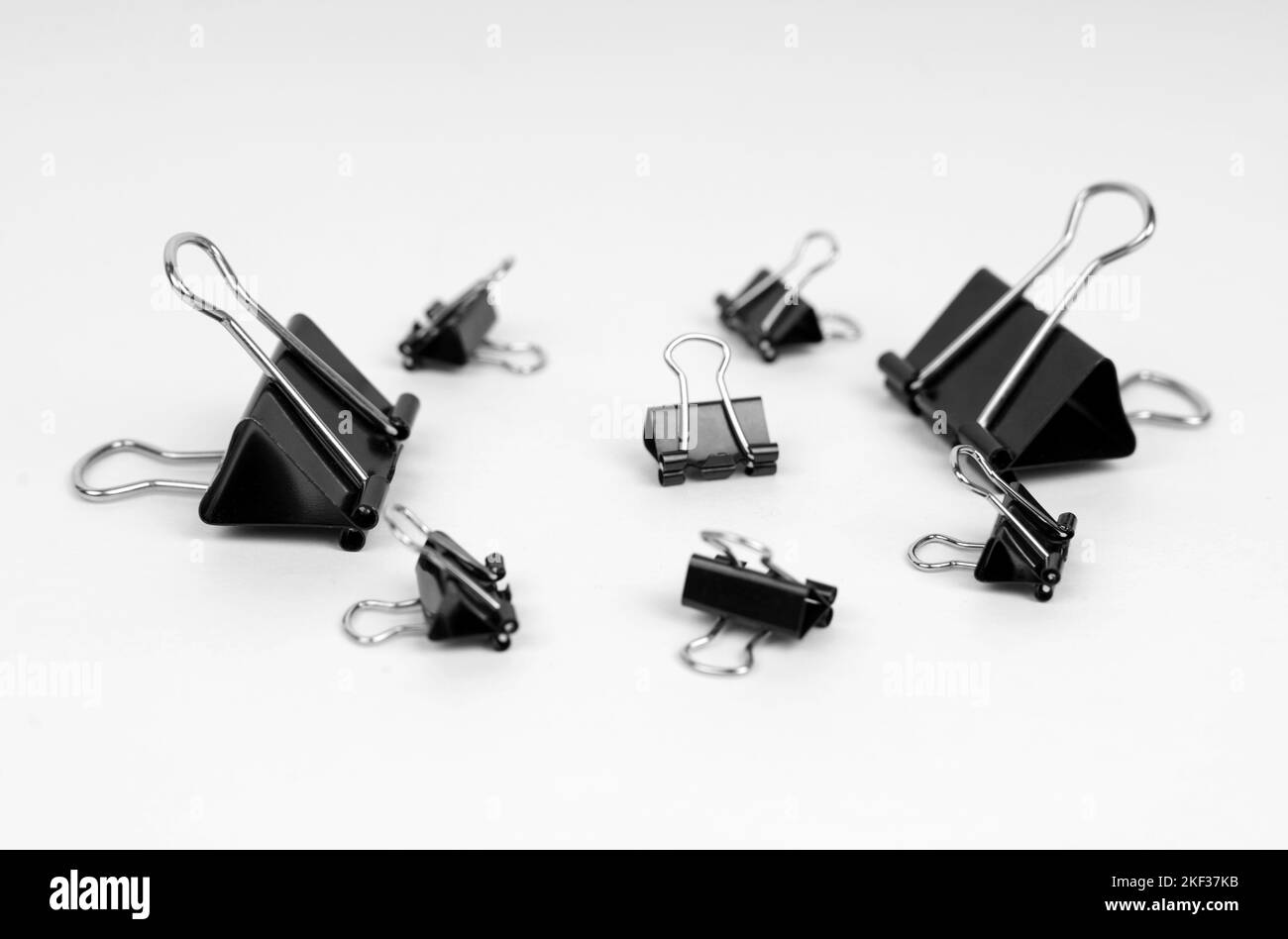 Office. Black clips of different sizes are on a white background Stock ...