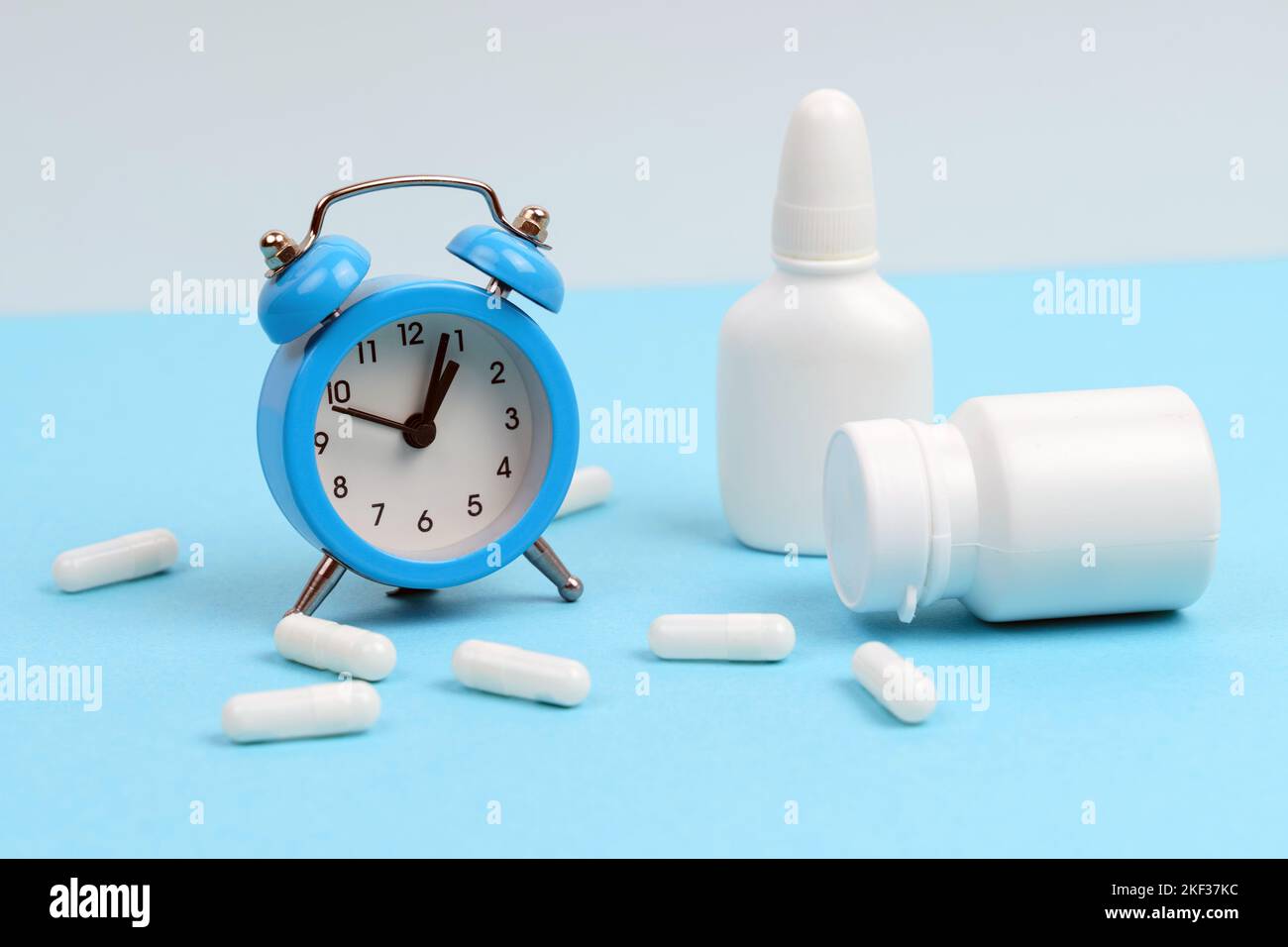 Medical concept. On a blue and white background, a blue clock, white ...