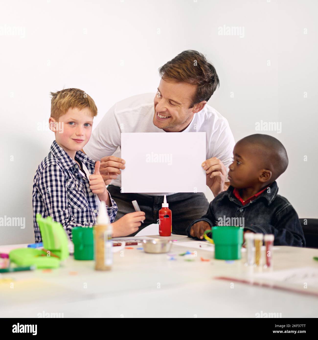 Giving him a voice. a volunteer holding up a blank sign while working ...