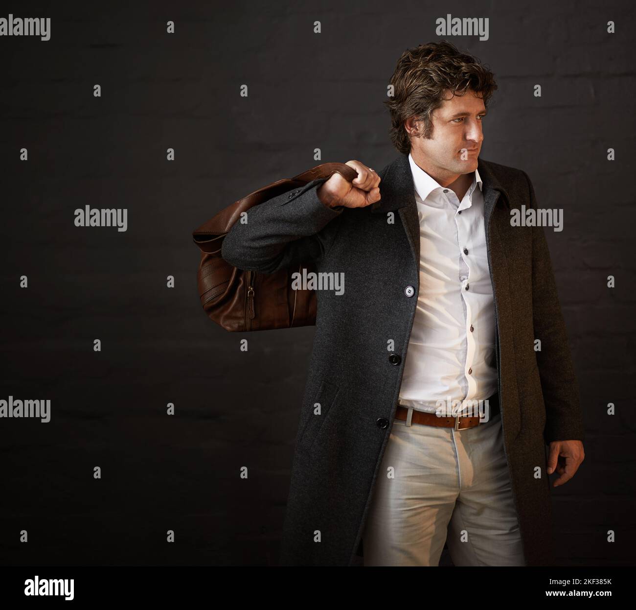 Hes got success in the bag. a well dressed businessman carrying a bag ...