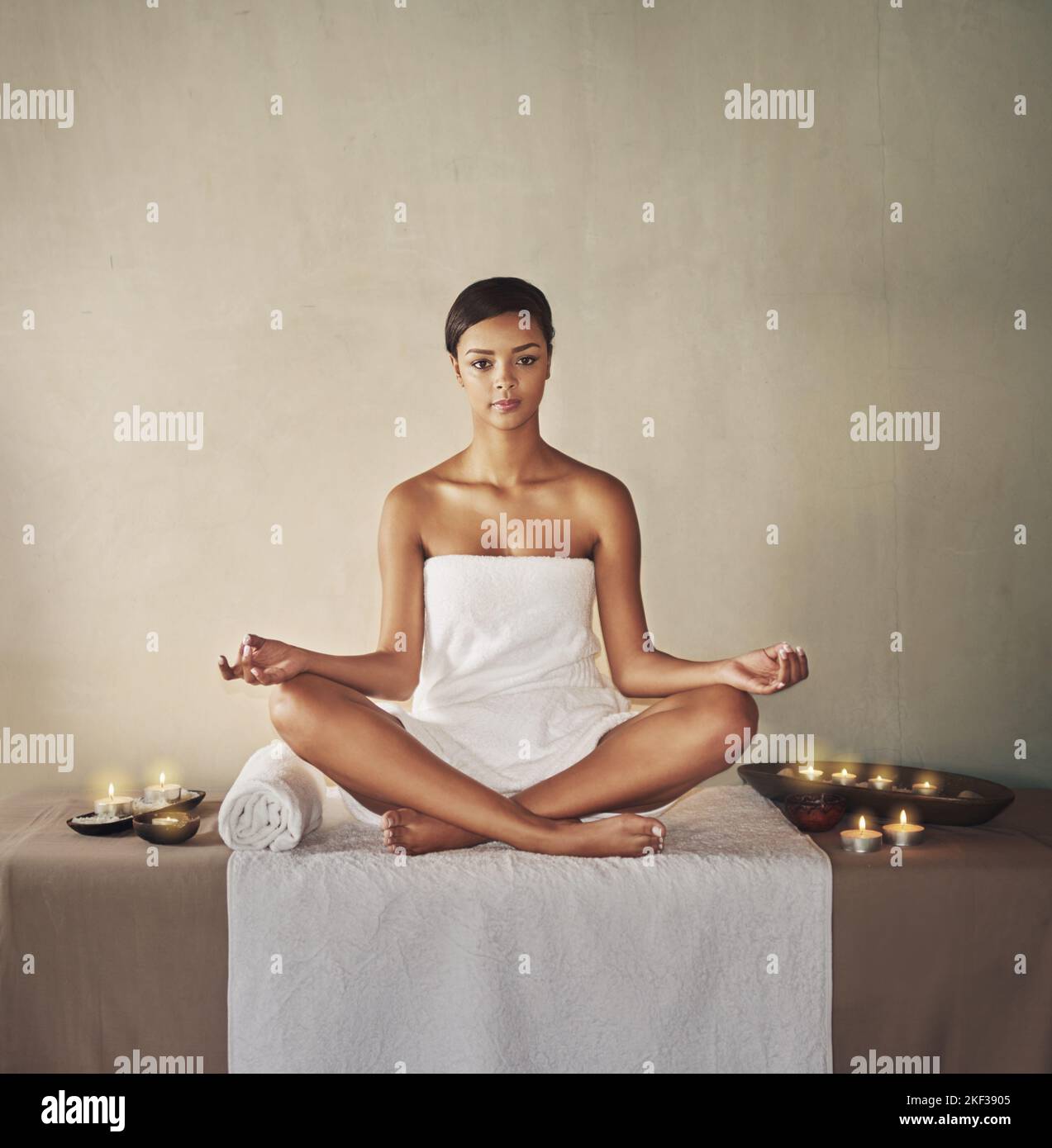 Spa indulgence. Full length portrait of a young woman meditating on a ...