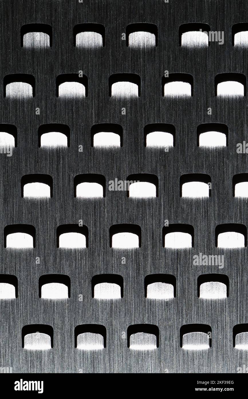 An extreme close-up of the outer side of a shiny, silver metal food ...