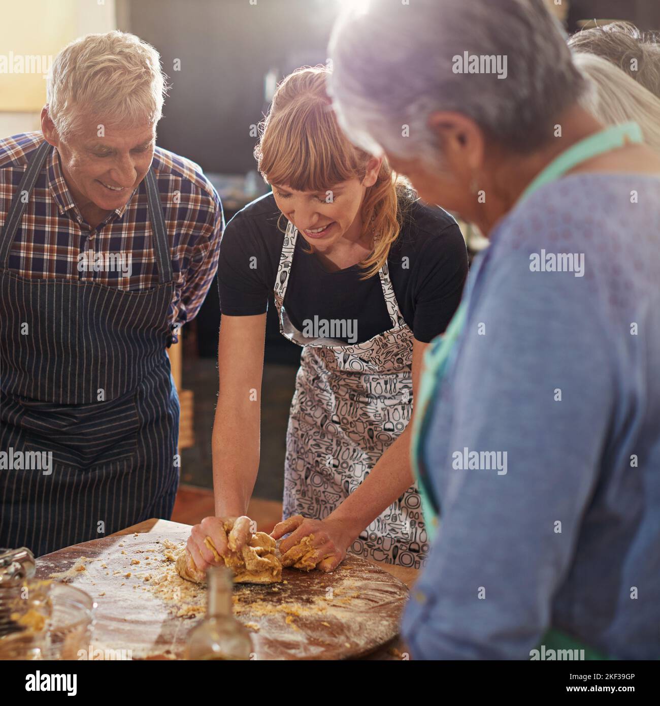 Showing them how to make the perfect dough. a group of seniors ...