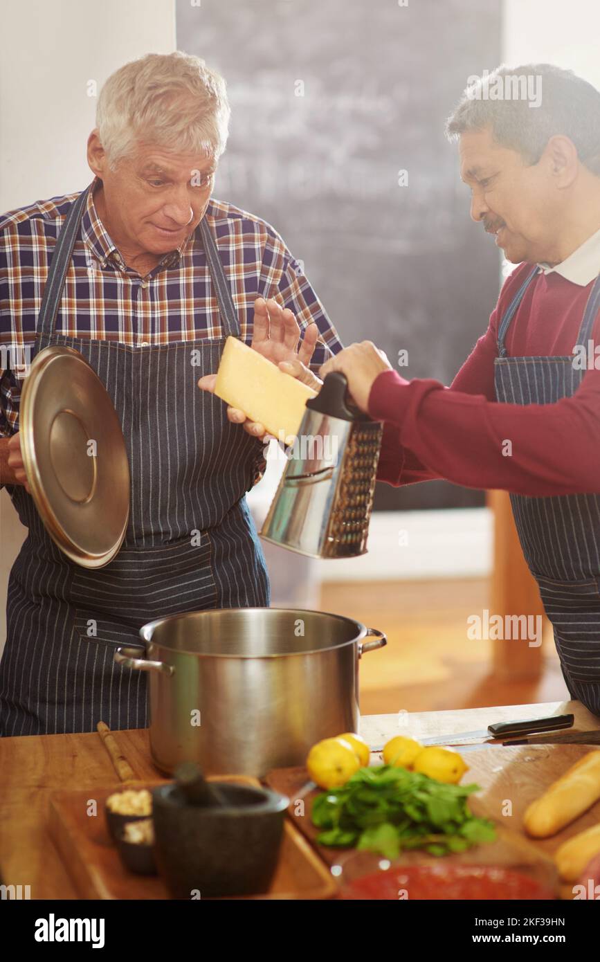 Two elderly men preparing meal hi-res stock photography and images - Alamy