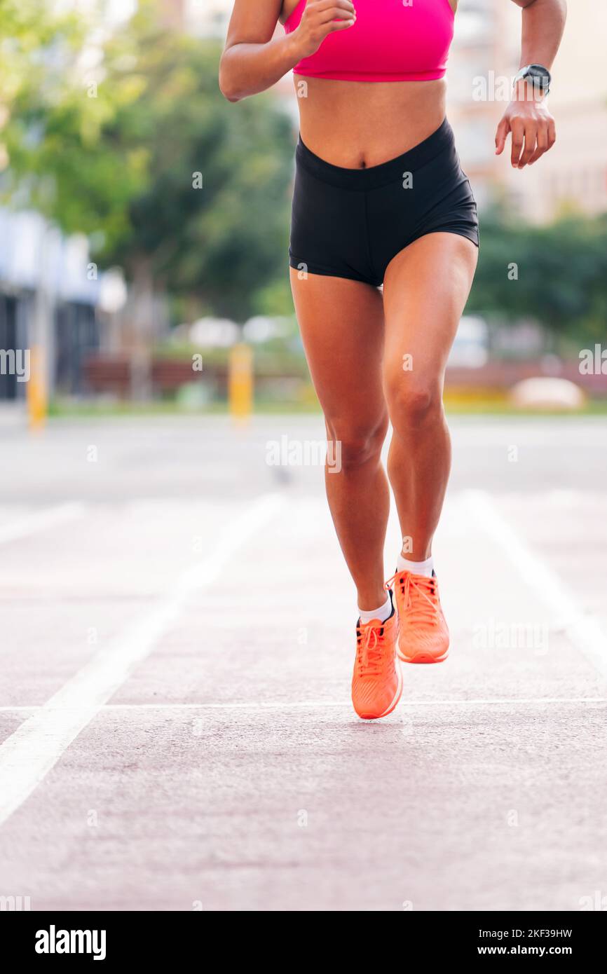legs of sportswoman running on the athletics track Stock Photo - Alamy