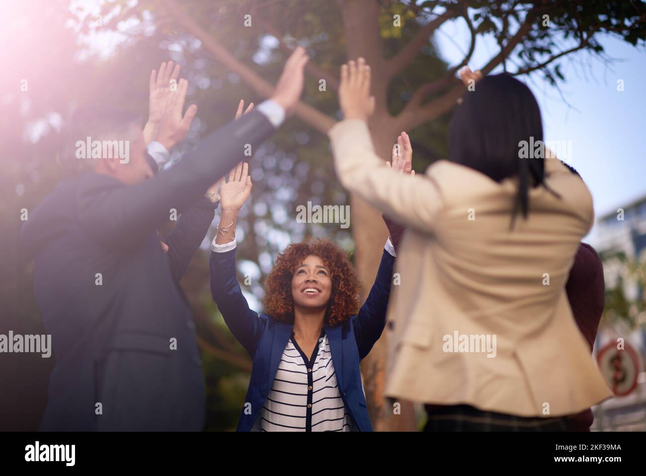 Lets do this together. Low angle shot of a business team huddling ...