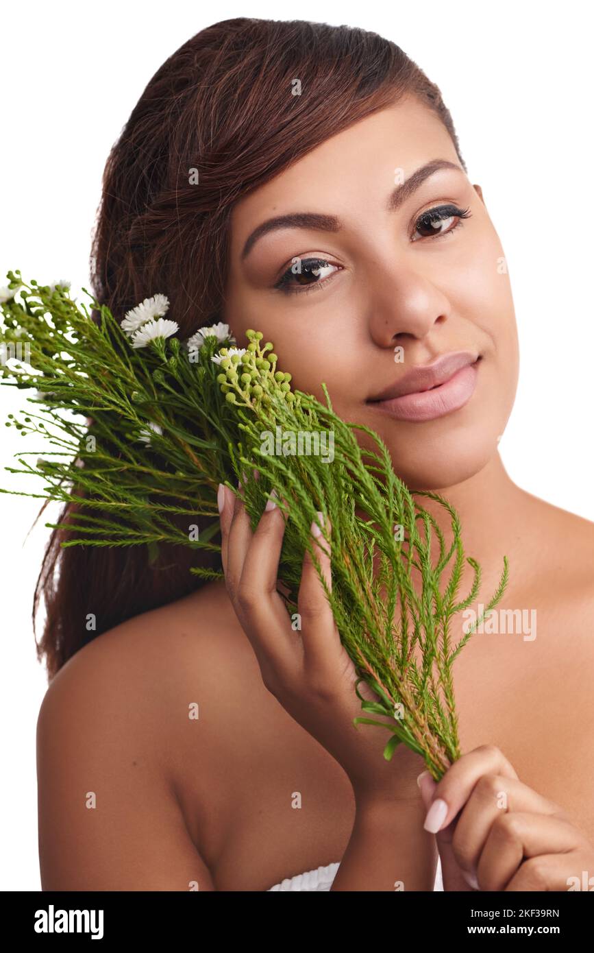 Pure natural beauty. a beautiful young woman posing with plants against ...