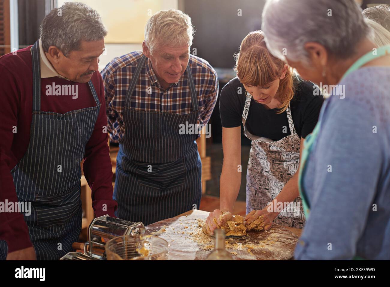 Showing them how to make meals in minutes. a group of seniors attending ...