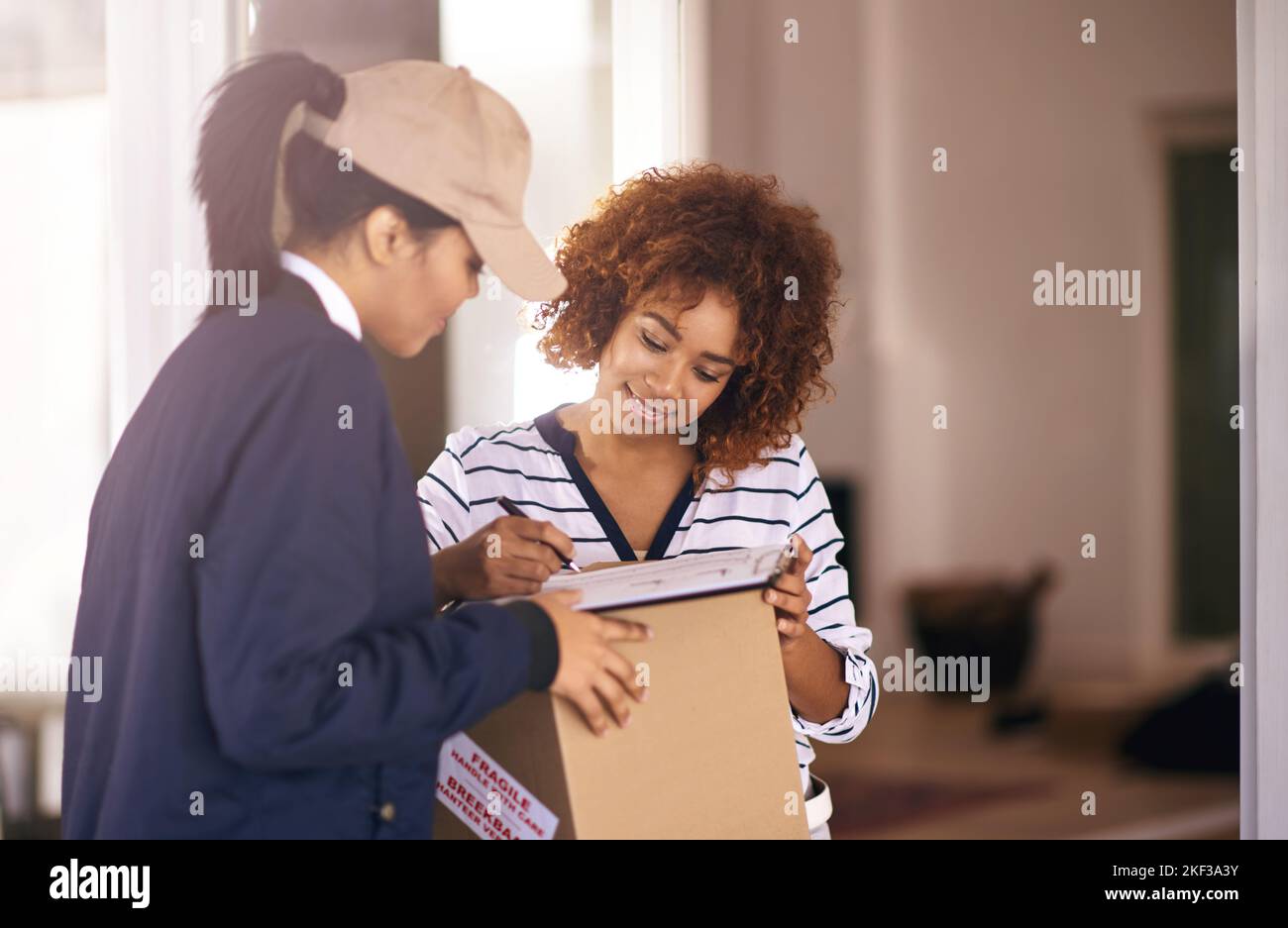 Happy woman receiving package hi-res stock photography and images - Alamy