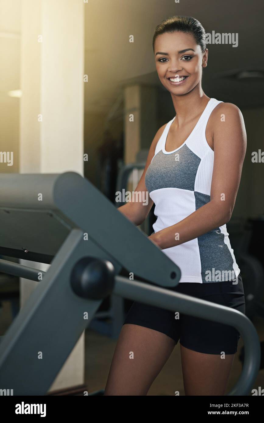 Exercise- her natural high. a young woman exercising on a treadmill at ...