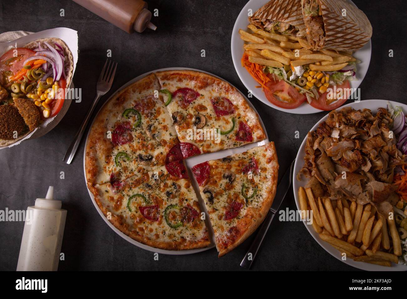 Top view of table scene with a variety of foods for take out or ...