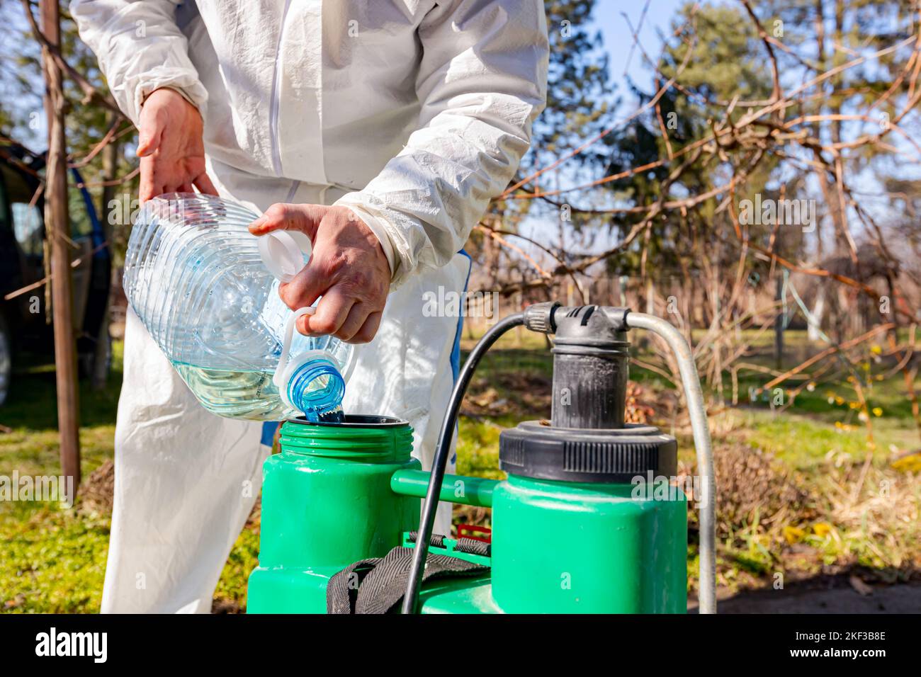 Farmer is preparing mixture of water and botanical solutions of ...