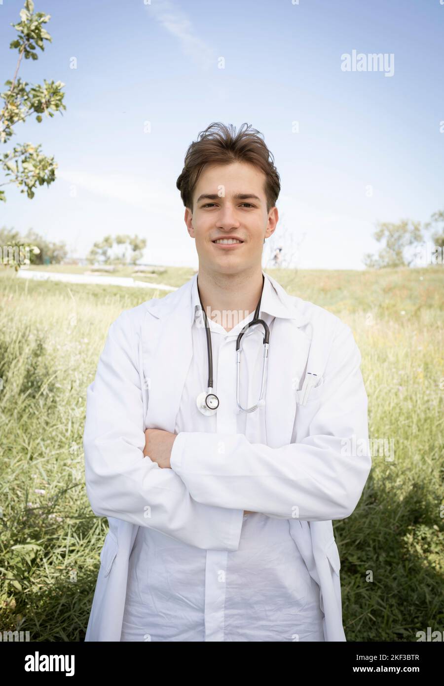 young sympathetic doctor with white coat and stethoscope around his ...
