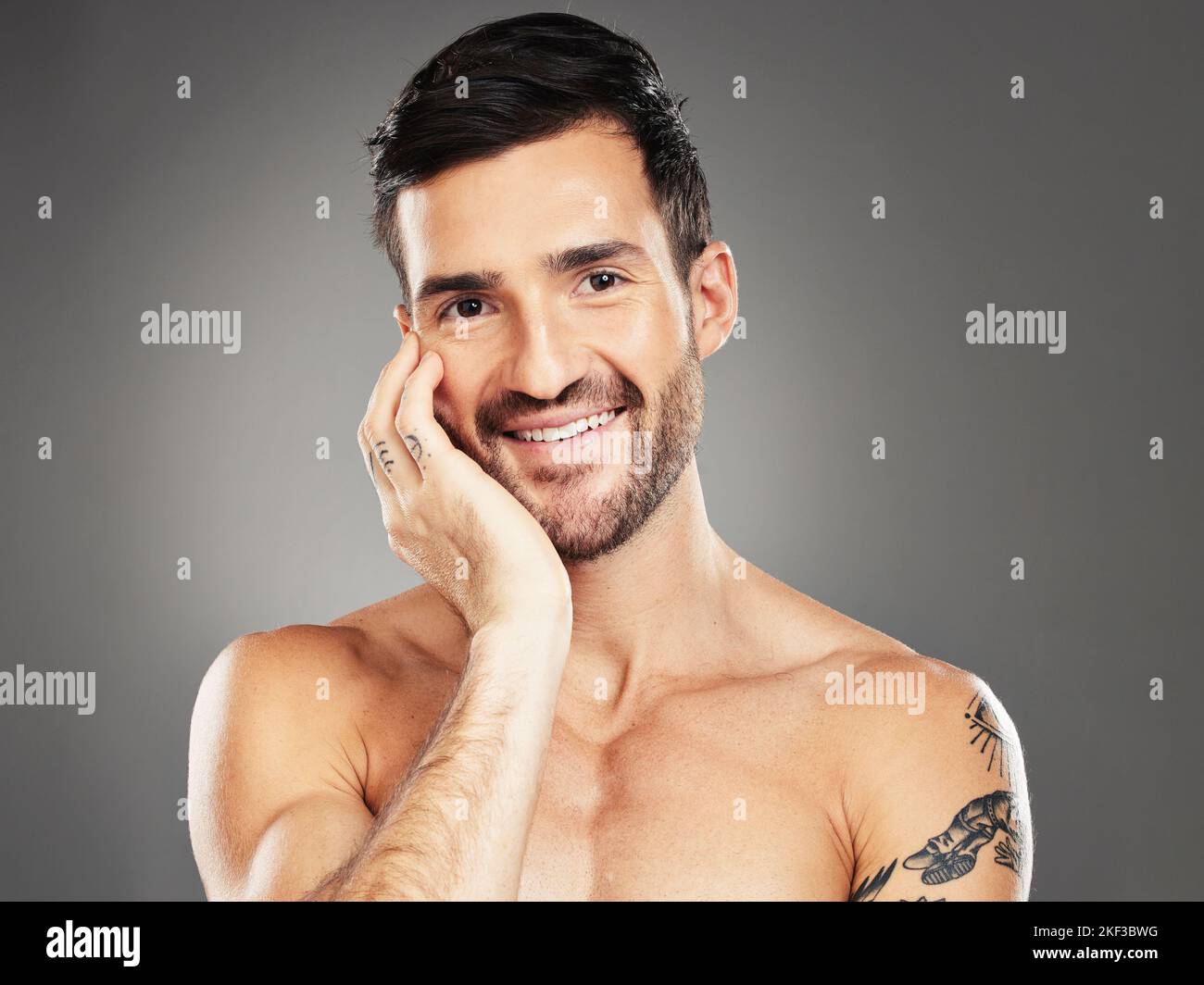 Face, beauty and portrait with a man model in studio on a gray ...