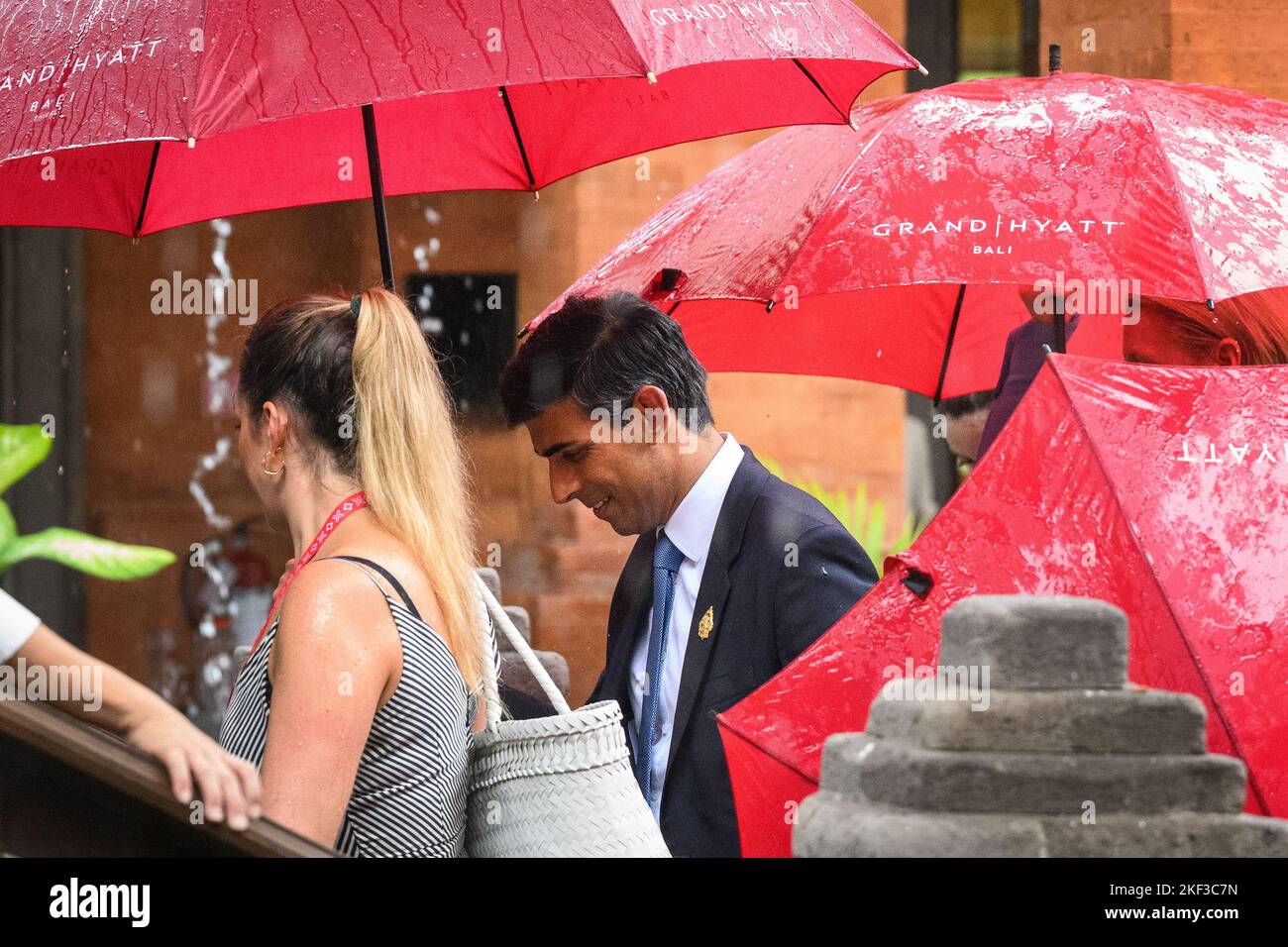 Prime Minister Rishi Sunak walks through the heavy rain after holding a ...