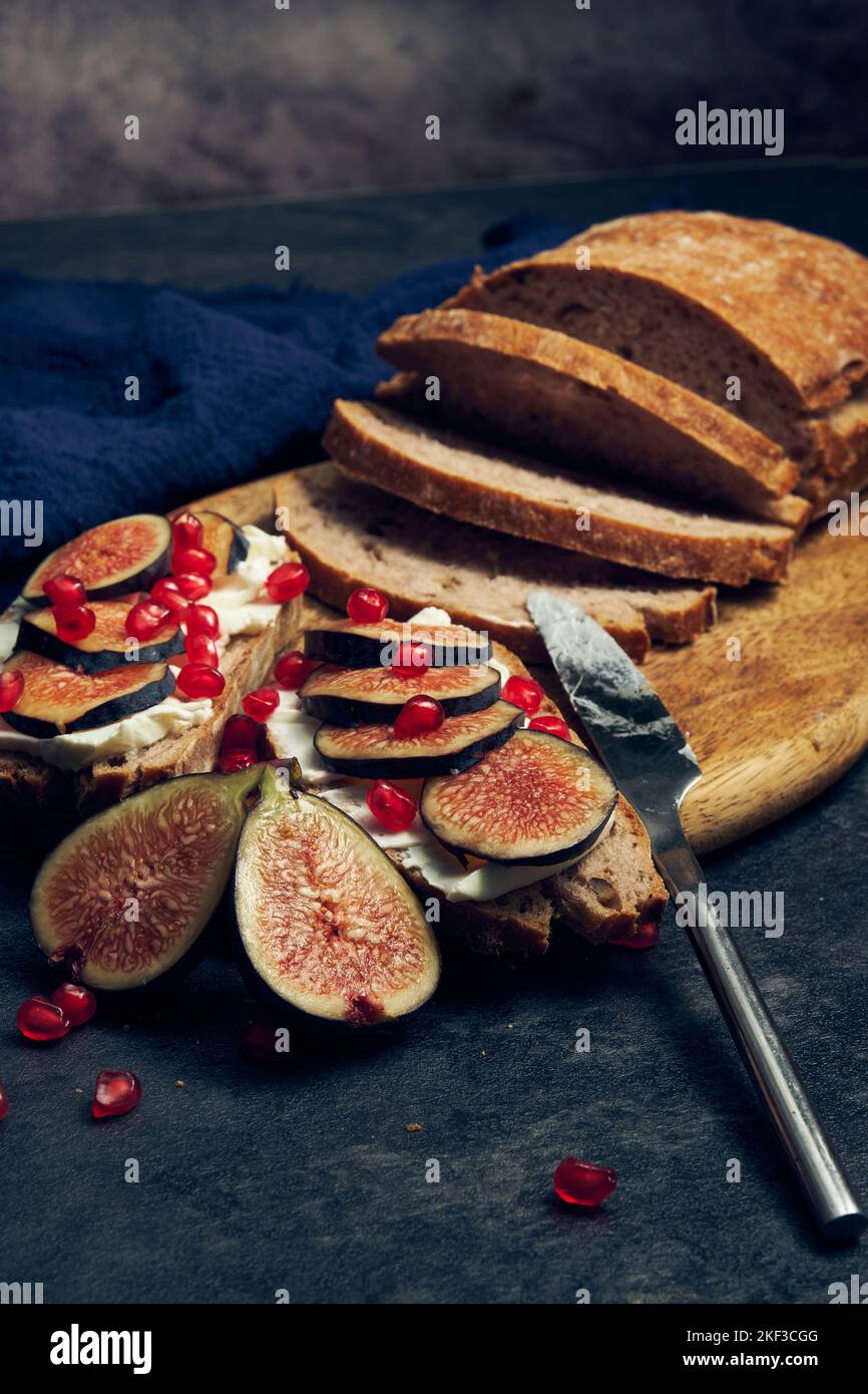 slices of rye bread with figs and pomegranate Stock Photo - Alamy