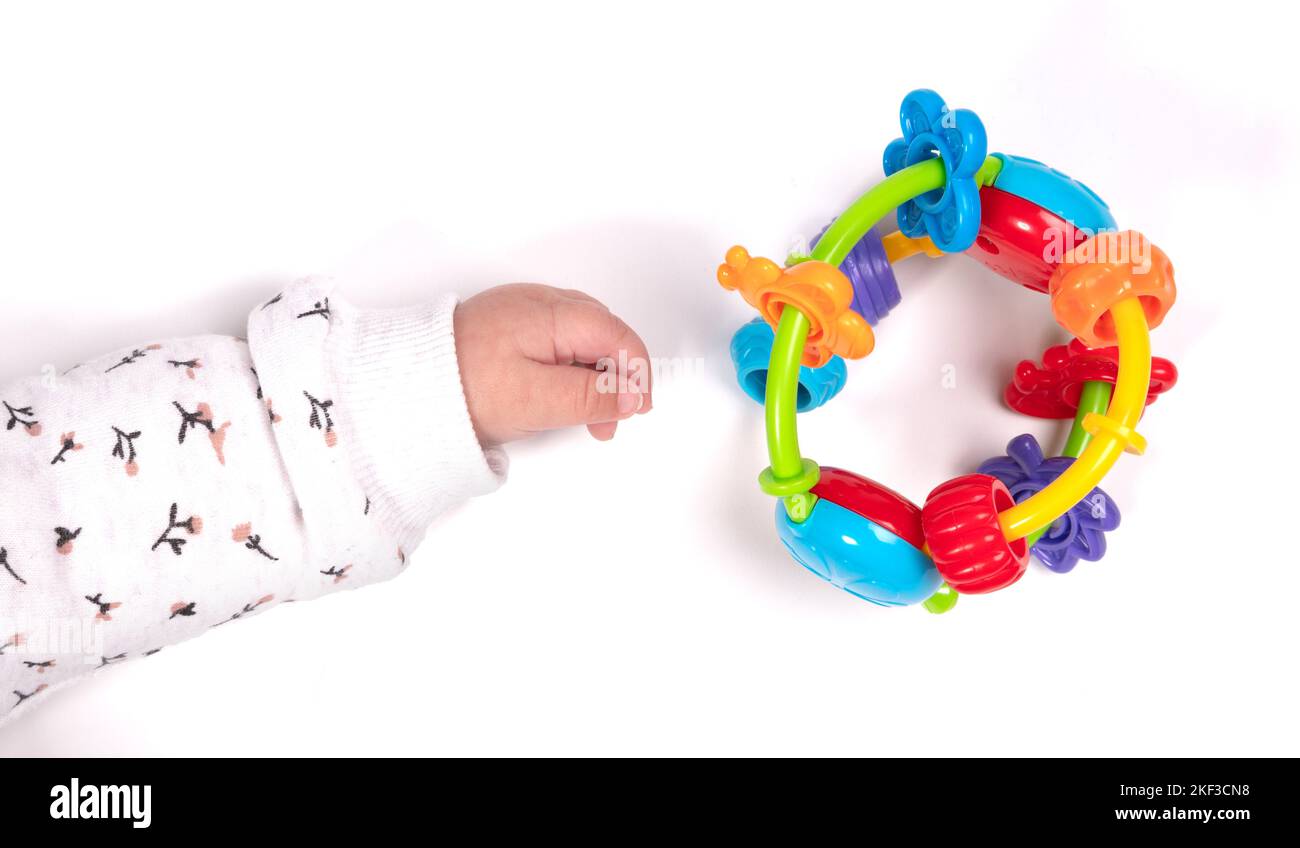 Baby hand (female) reaching for a toy, isolated on white background ...