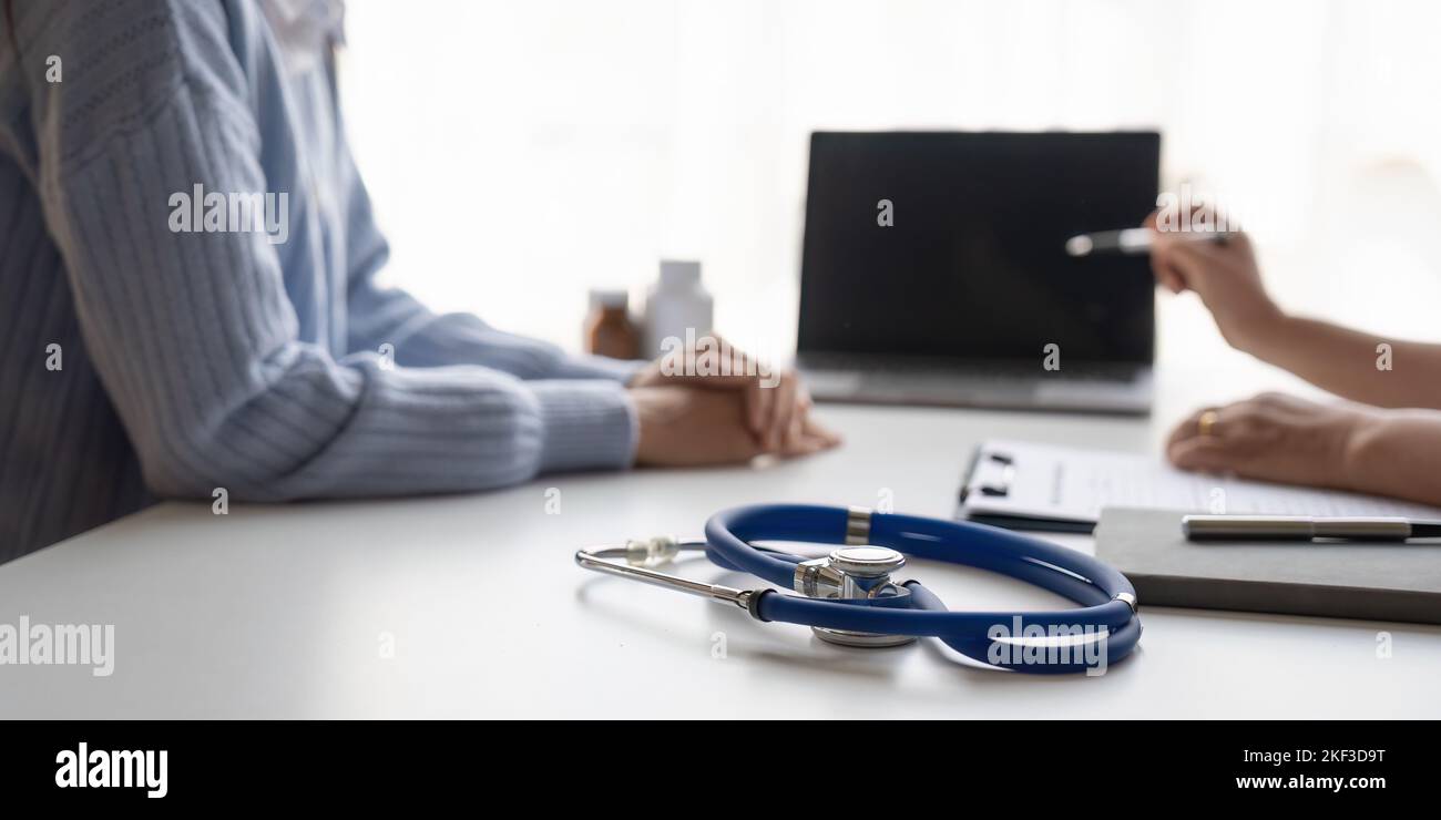 medical consultation - doctor talking to patient in clinic office on ...