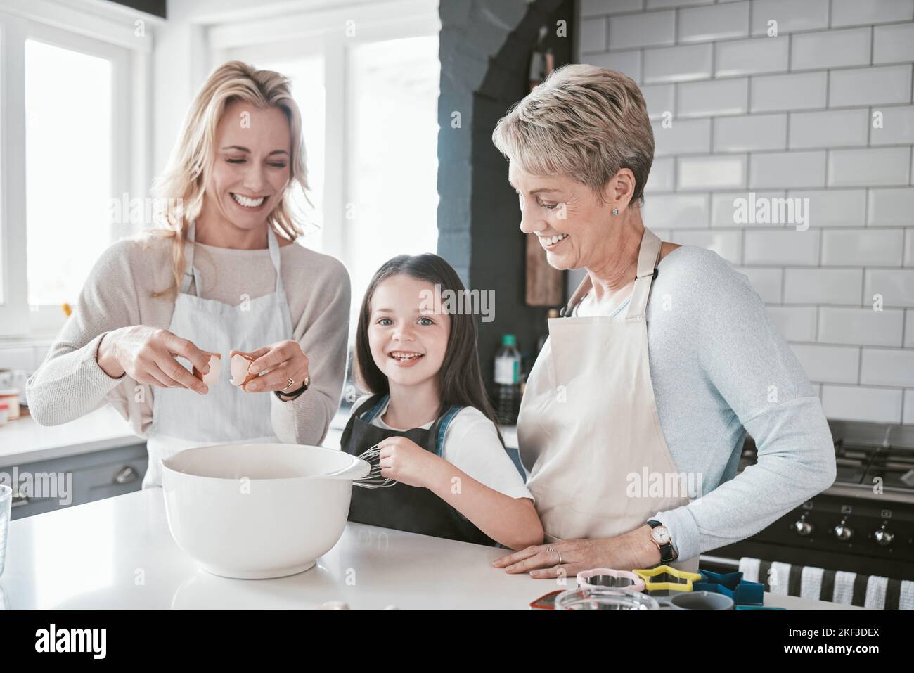 .Family, learning and cooking with grandmother in kitchen together for ...