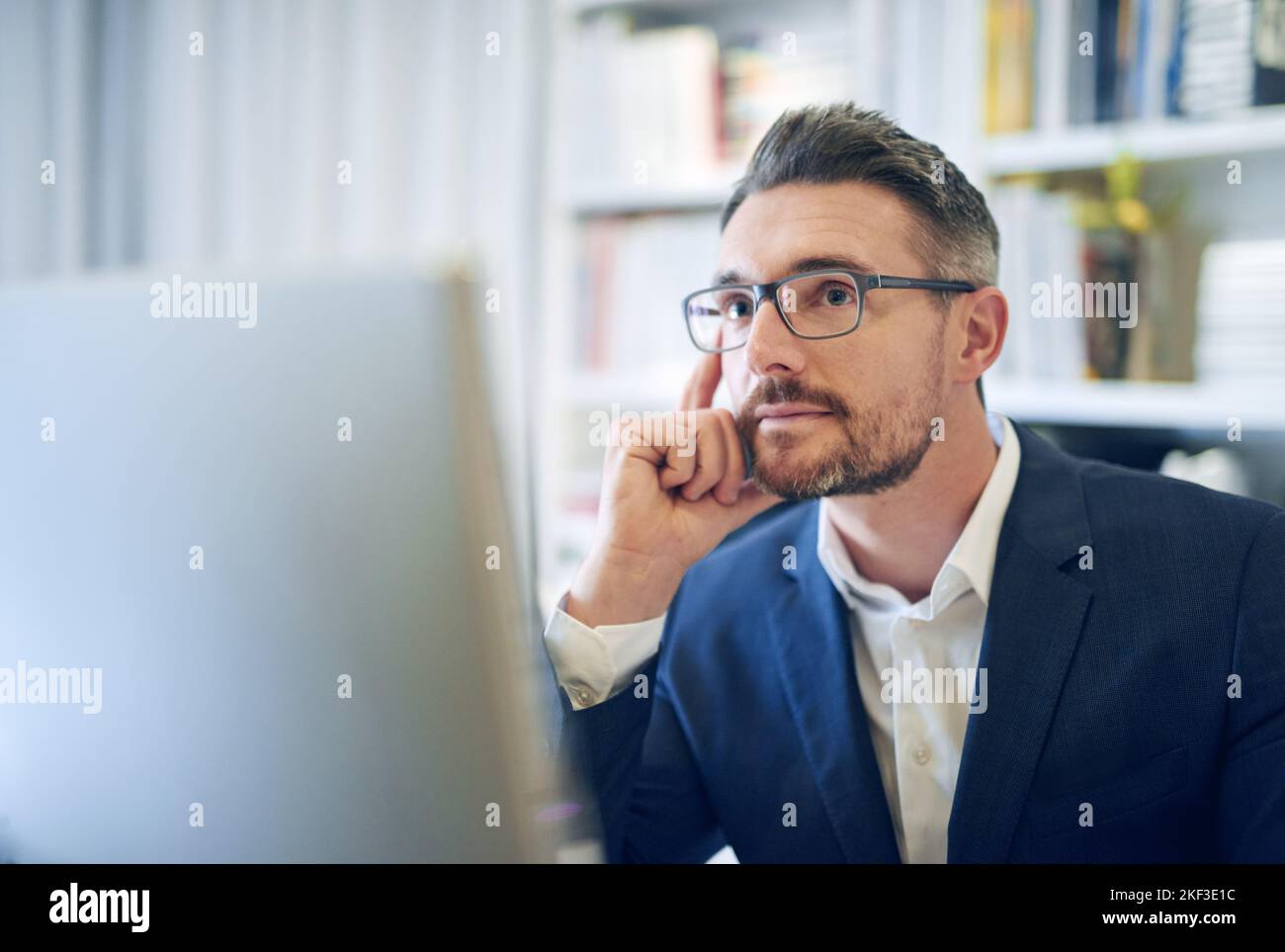 Hes an astute businessman. a mature businessman deep in thought while ...