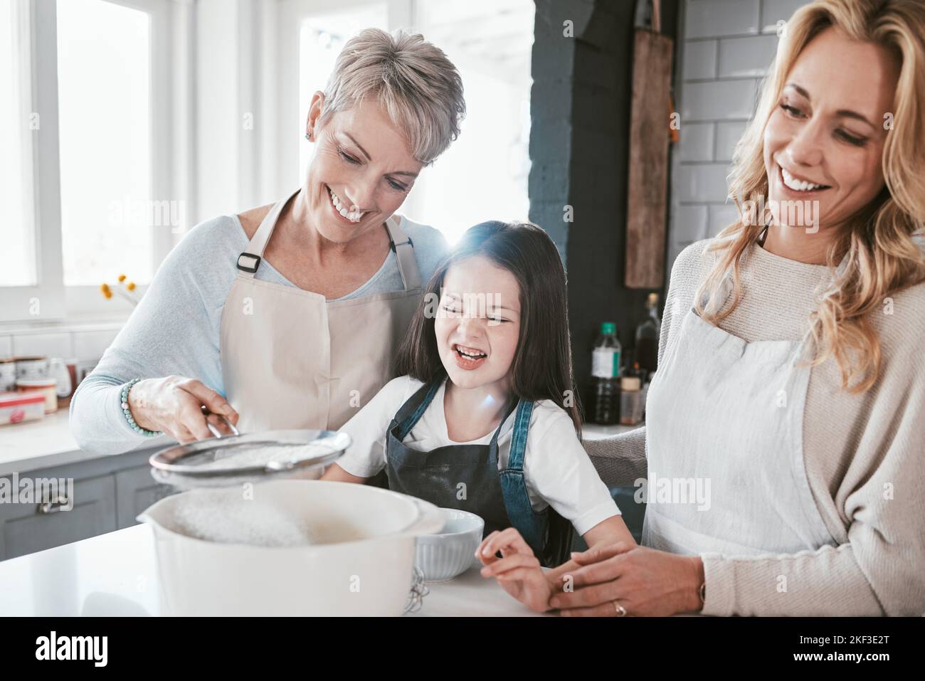 .Family, grandmother and child cooking together in kitchen for learning ...