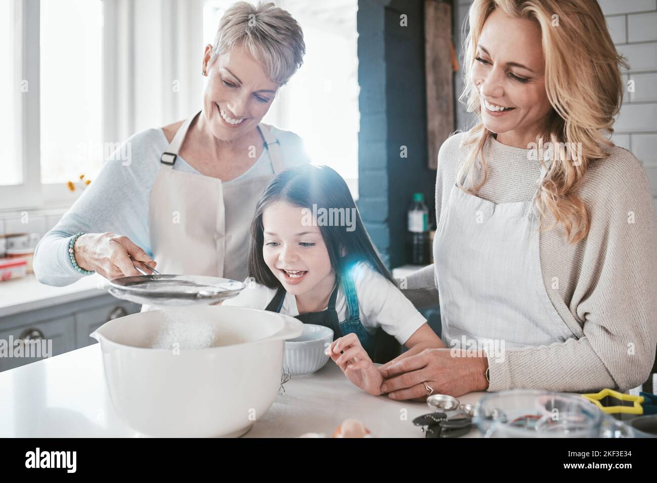 .Family, children and baking with a grandmother, mother and daughter in ...