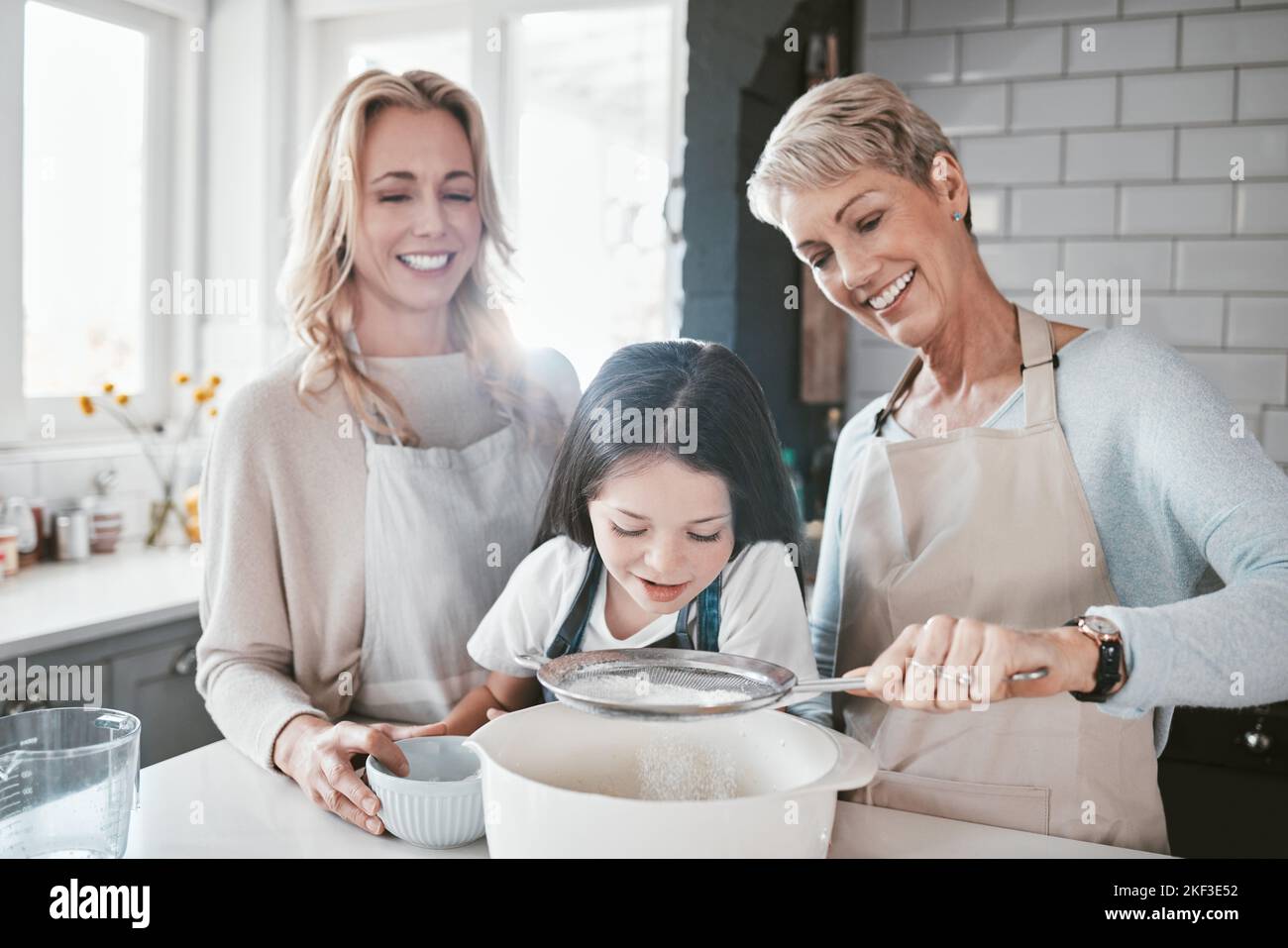 Happy family cooking of child, mother and grandmother teaching youth ...
