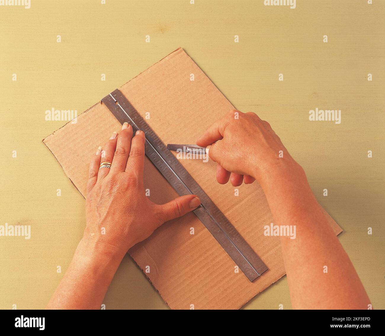 Drawing an indent line on corrugated cardboard Stock Photo - Alamy