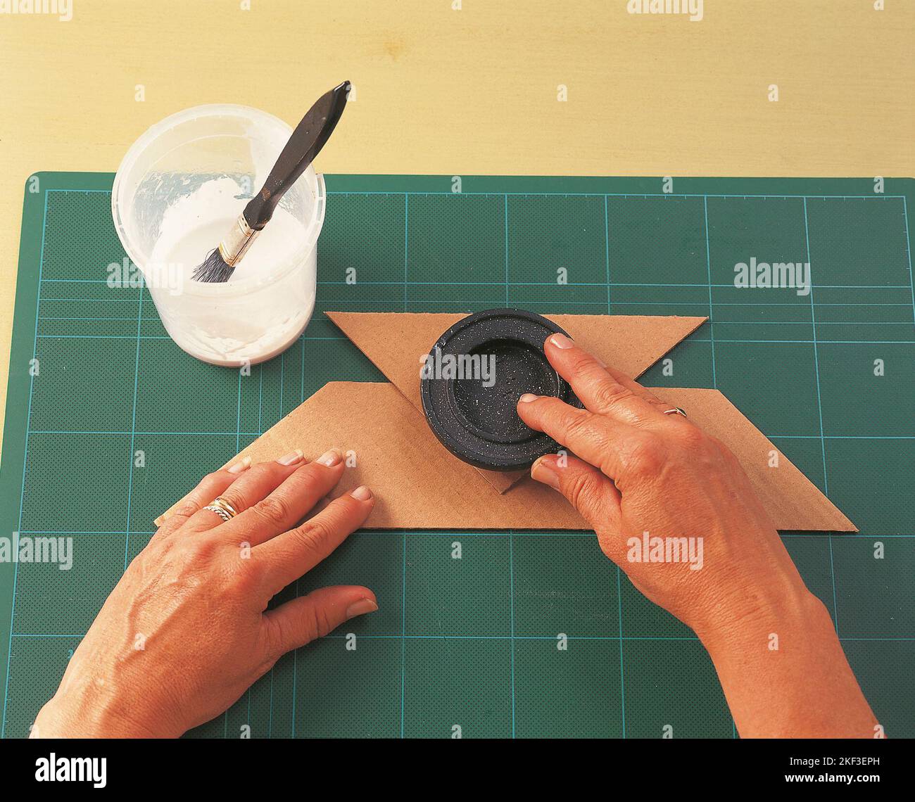 Bonding two surfaces of the cardboard with a weight Stock Photo - Alamy