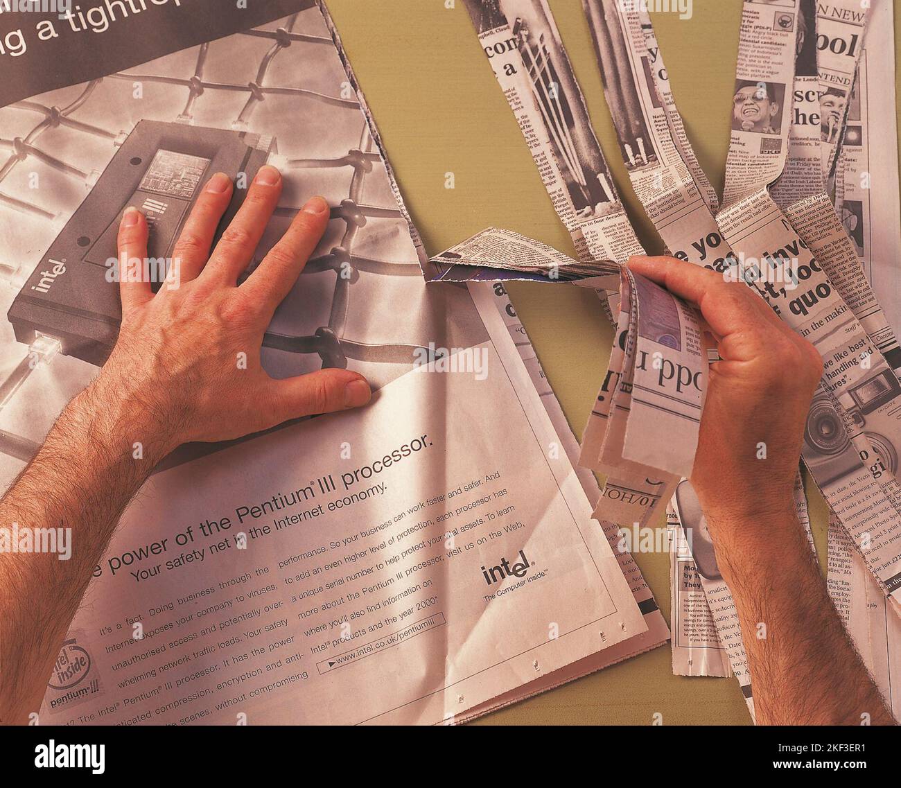 Tearing old newspapers into long strips Stock Photo - Alamy