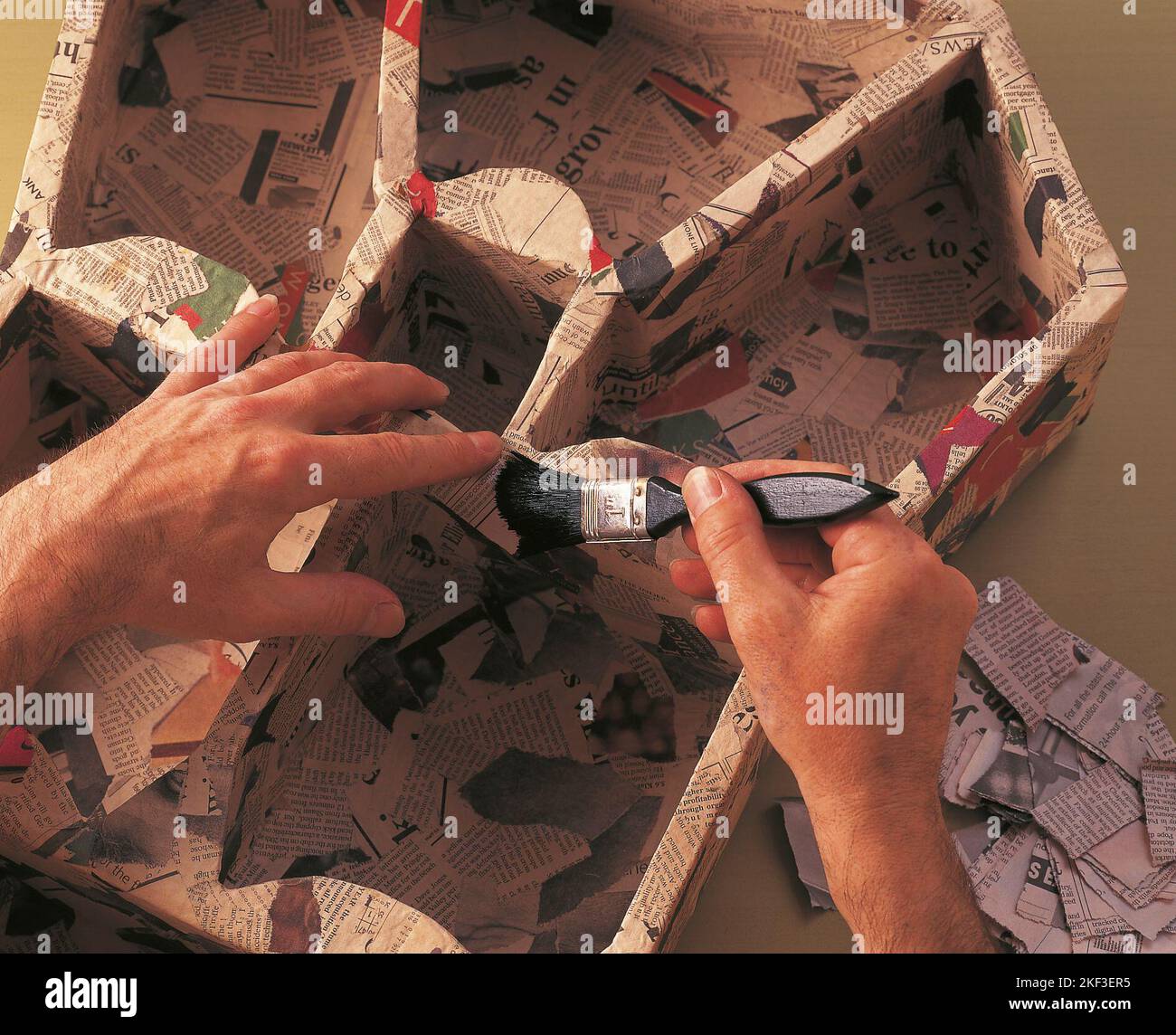 Covering the cardboard base structure with the squares Stock Photo - Alamy